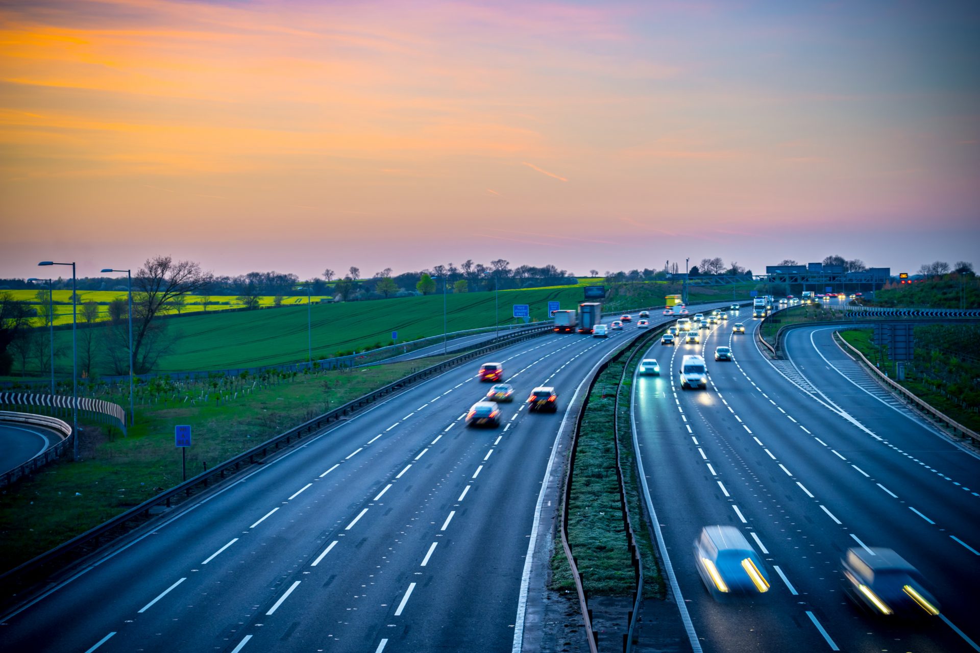 Colourful sunset at M1 motorway near Flitwick junction with blurry cars ...